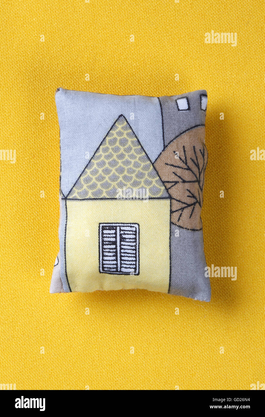 Cushion with little house Stock Photo - Alamy
