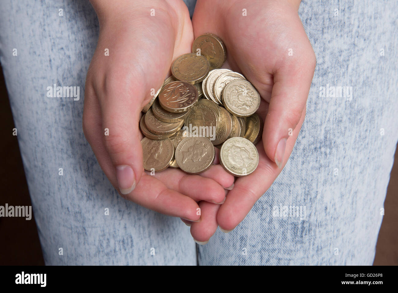 Palm of pound coins Stock Photo - Alamy