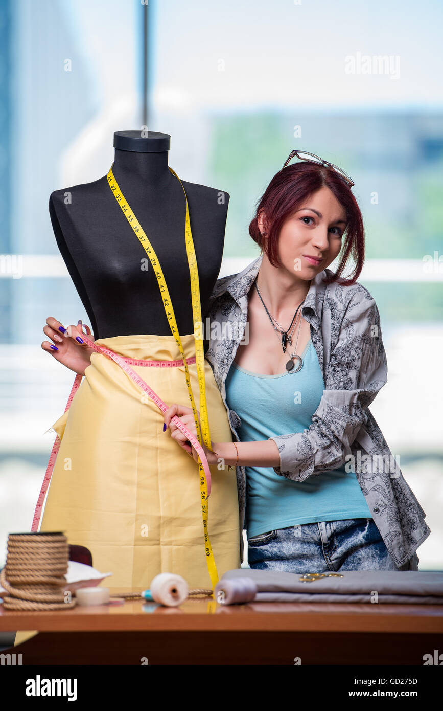 Woman tailor working at her desk Stock Photo - Alamy