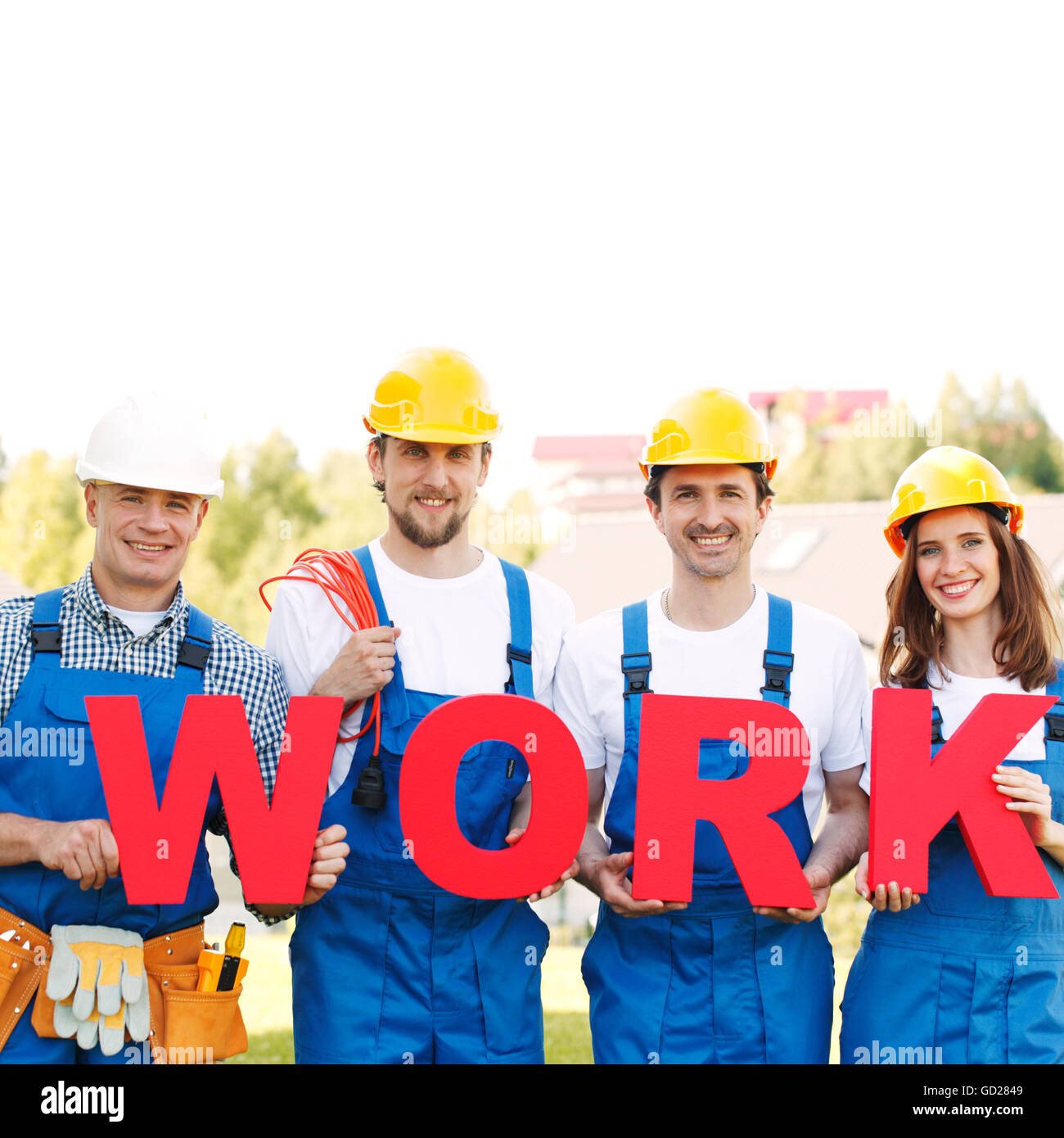 Team of happy workers with work letters and tools Stock Photo - Alamy