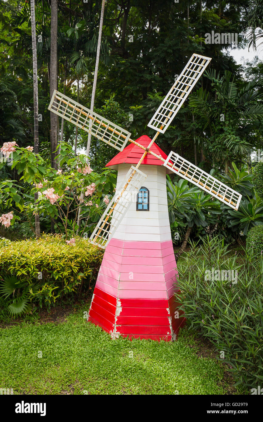 Colorful lighthouse wind turbine decorating in green garden surround by ...