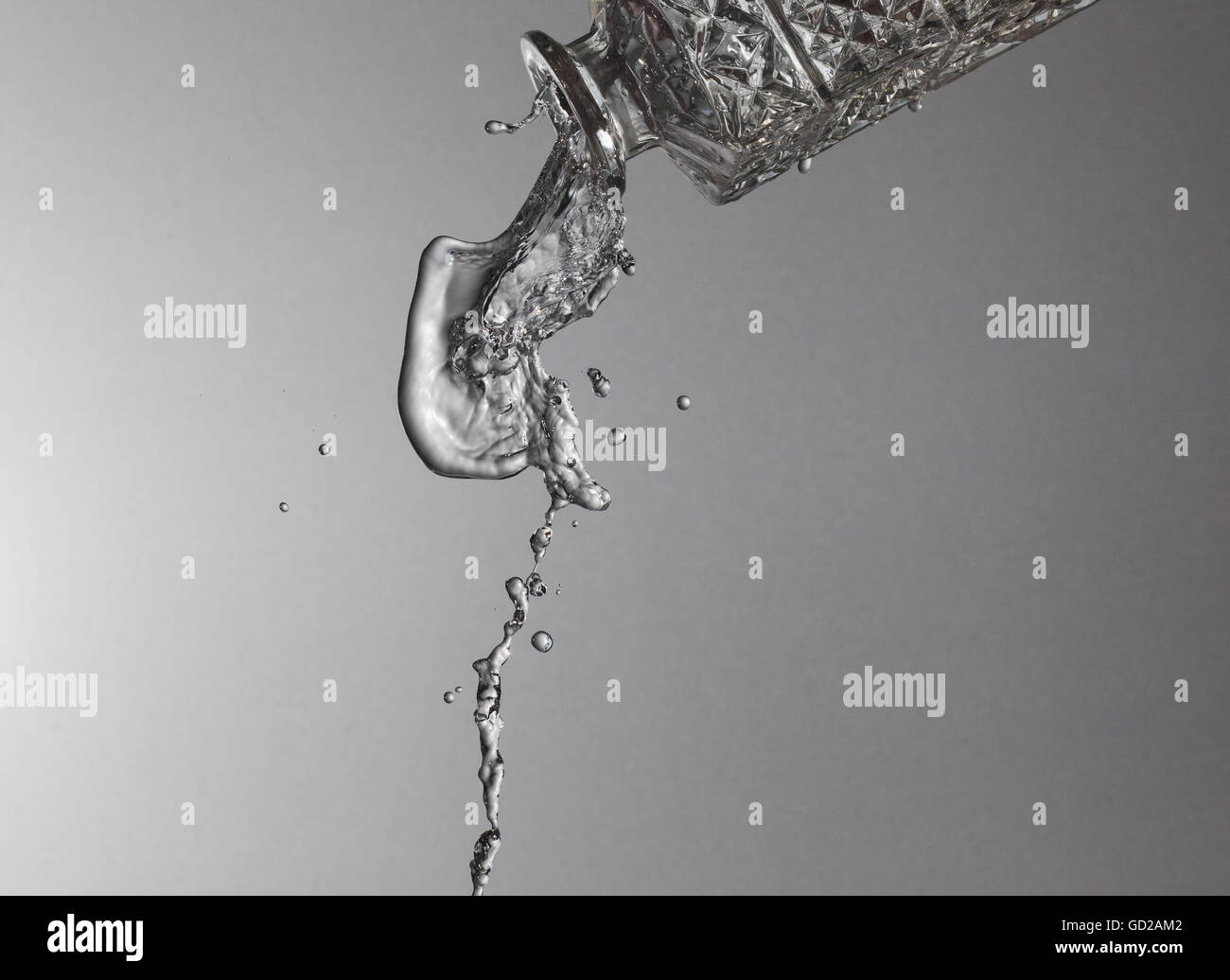 Stream of water on a silver background Stock Photo - Alamy