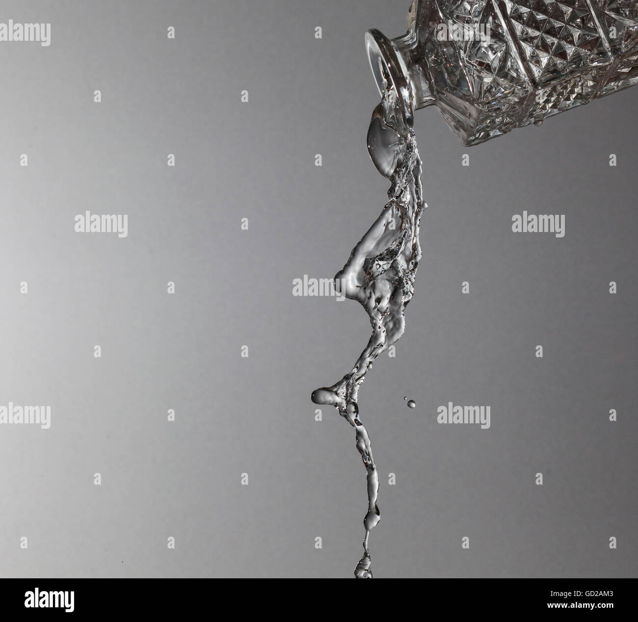 Stream of water on a silver background Stock Photo - Alamy