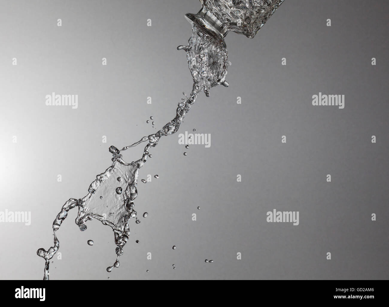 Stream of water on a silver background Stock Photo - Alamy