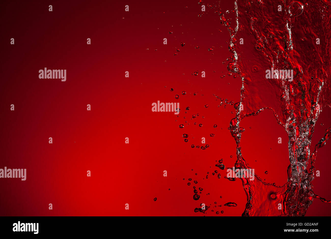Water splashes on a red background Stock Photo - Alamy