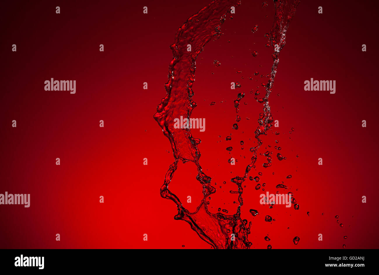 Water splashes on a red background Stock Photo - Alamy