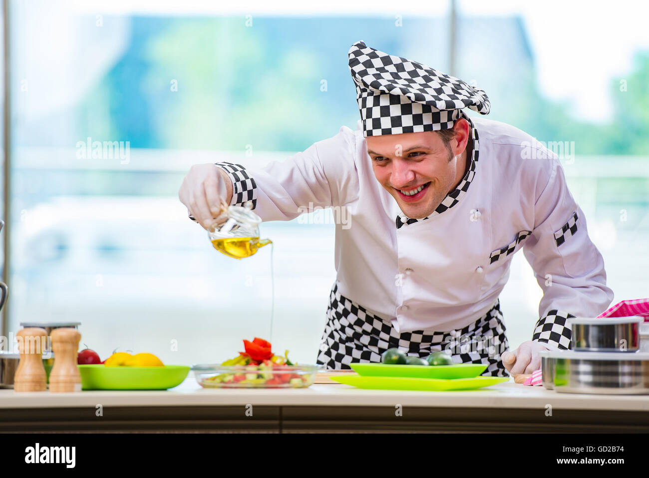 Male cook preparing food in the kitchen Stock Photo - Alamy