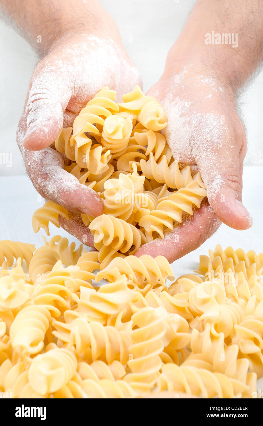 Male hands holding handmade rustic pasta Stock Photo - Alamy