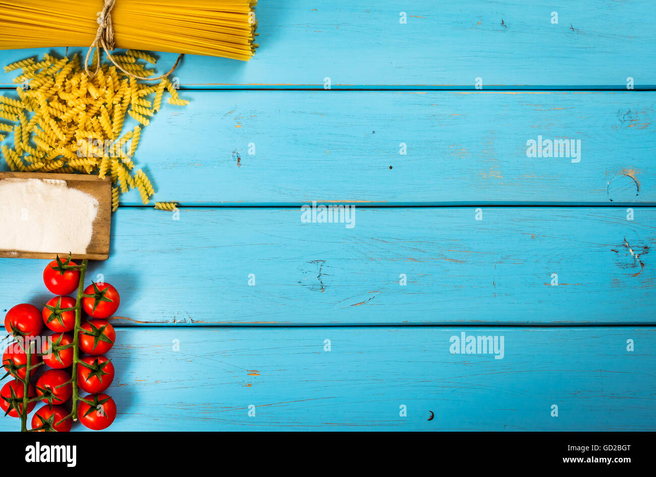 Food or cooking background with pasta, tomato, spaghetti, penne and ...