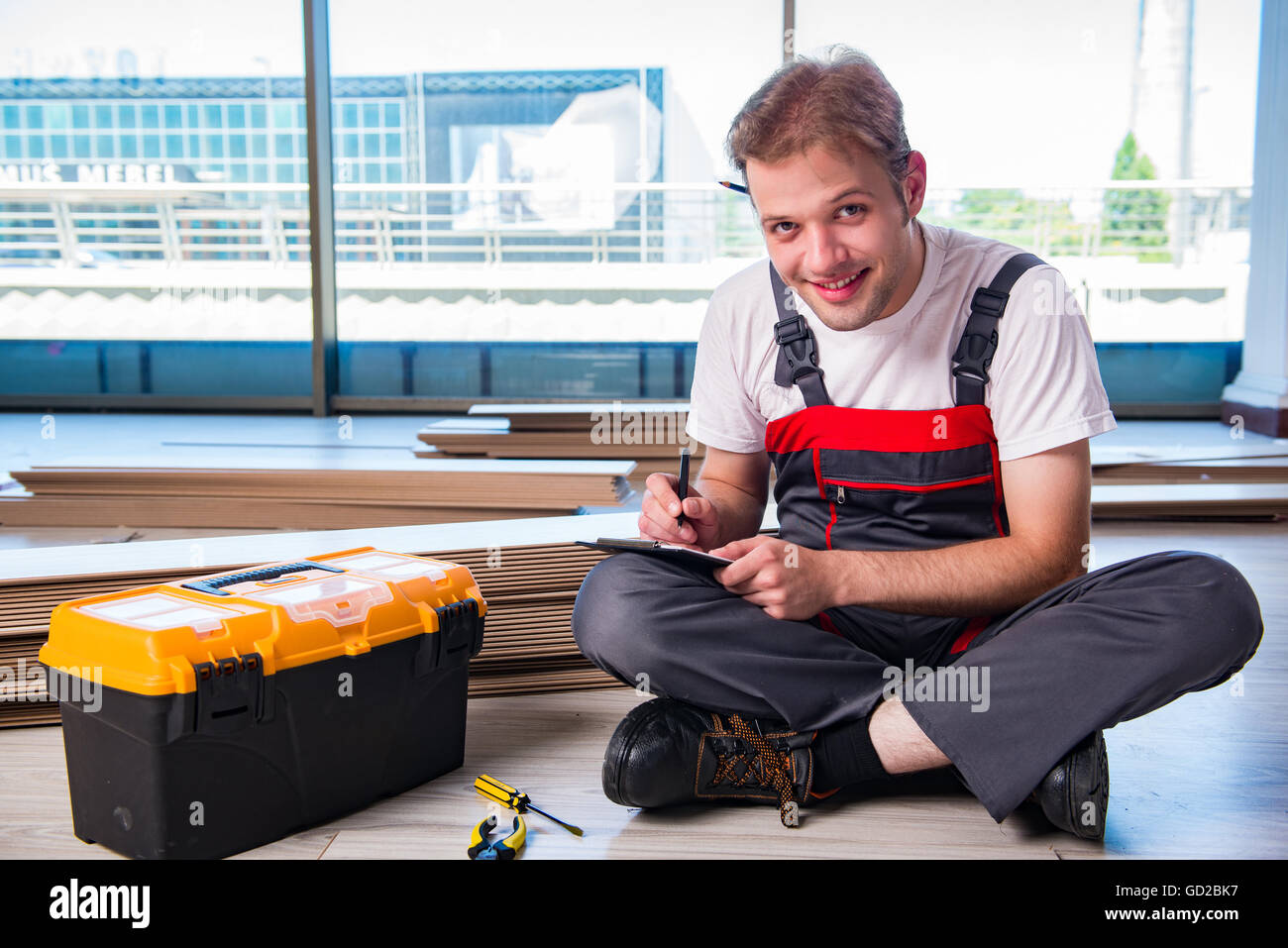 Man laying laminate flooring in construction concept Stock Photo - Alamy