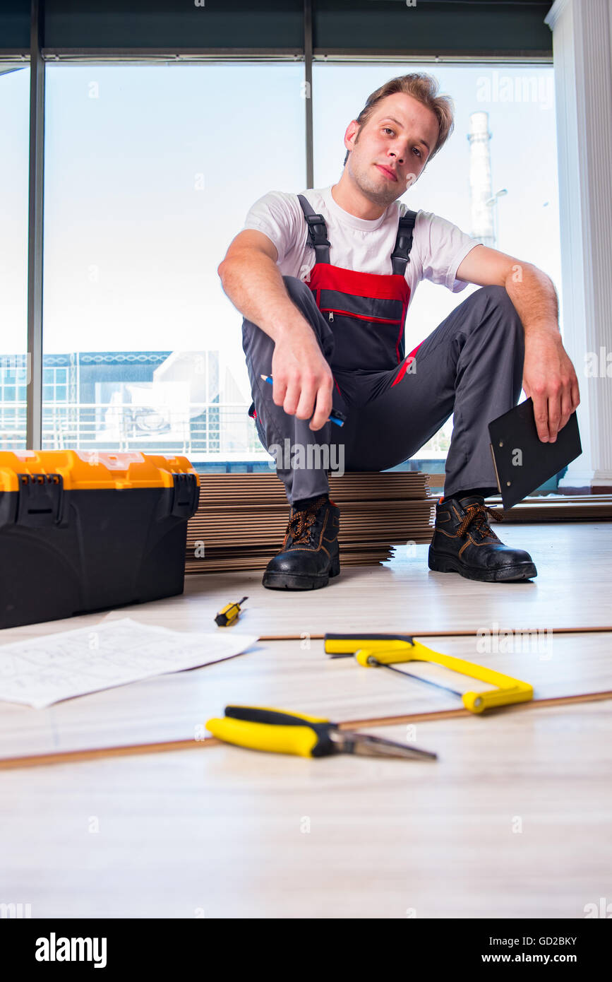 Man laying laminate flooring in construction concept Stock Photo - Alamy