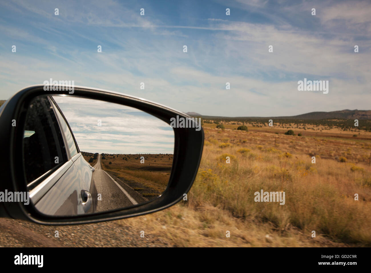 Driving route 66 with landscape reflected in car mirror; Arizona ...