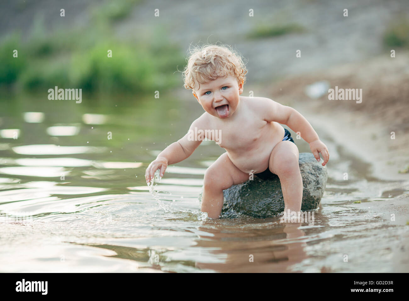 little funny boy playing in water Stock Photo - Alamy