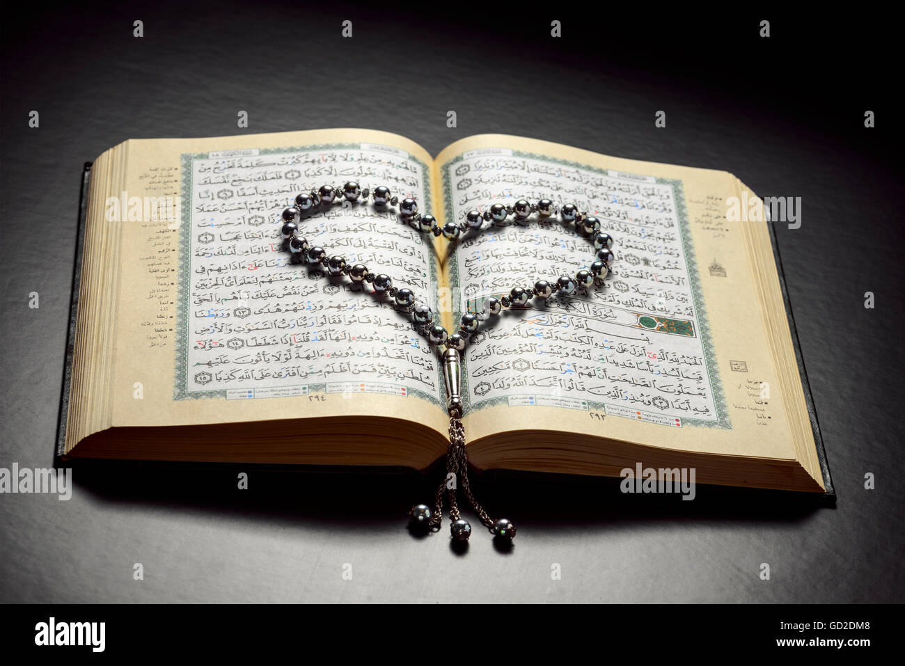 Islamic Book Holy Quran with Heart Shaped Subha on Black Background ...