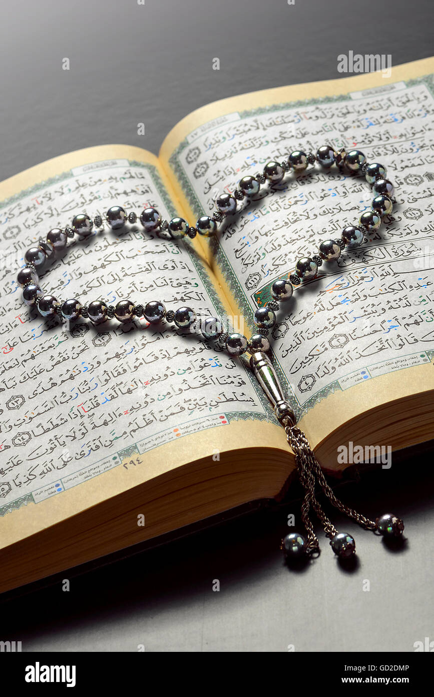 Closeup of Islamic Book Holy Quran with Heart Shaped Subha on Black ...