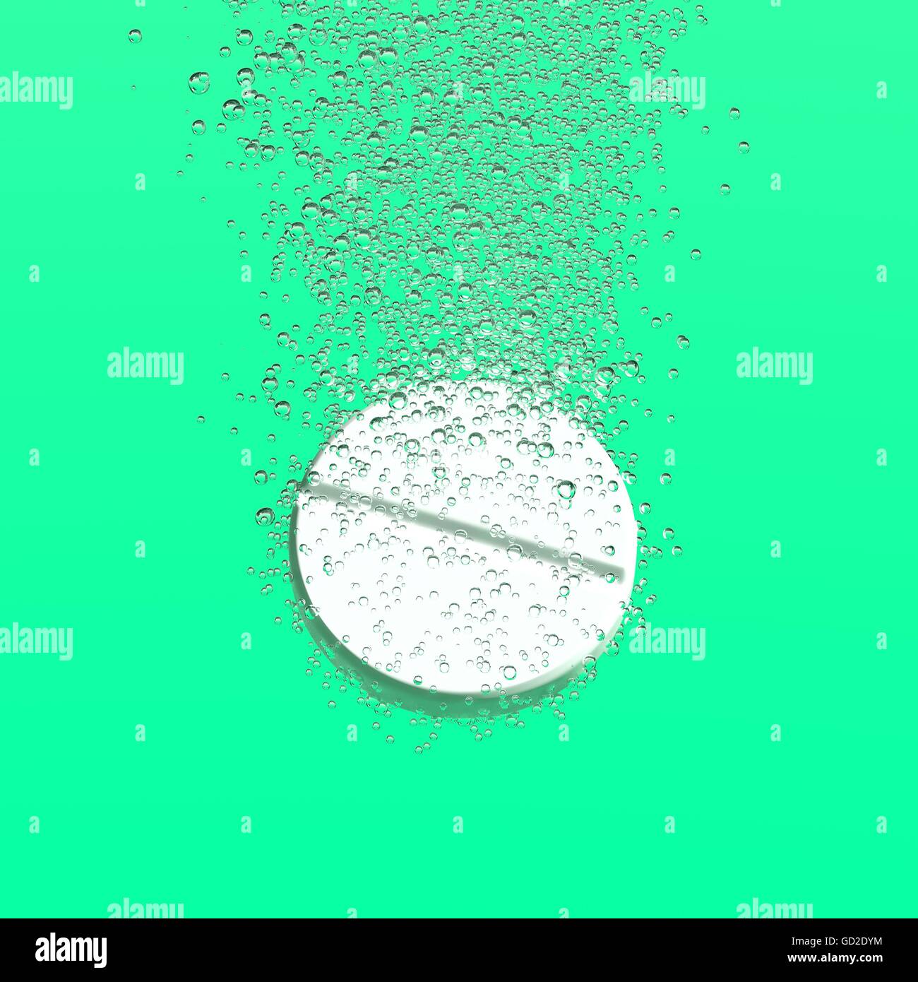 Effervescent medicine. Fizzy tablet dissolving. White round pill ...