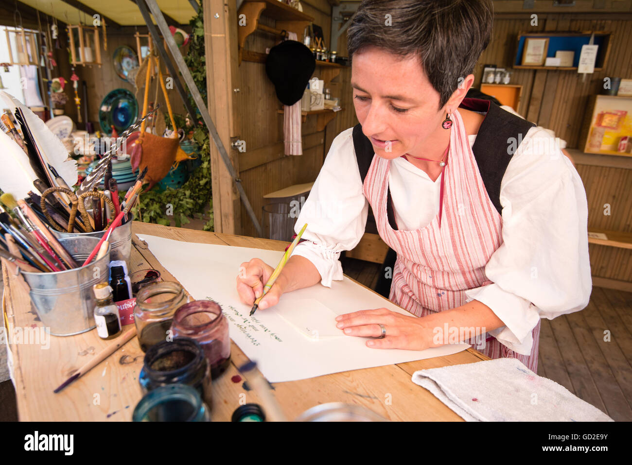 Friedberg, Germany - July 09, 2016: A female calligraphy writer is ...