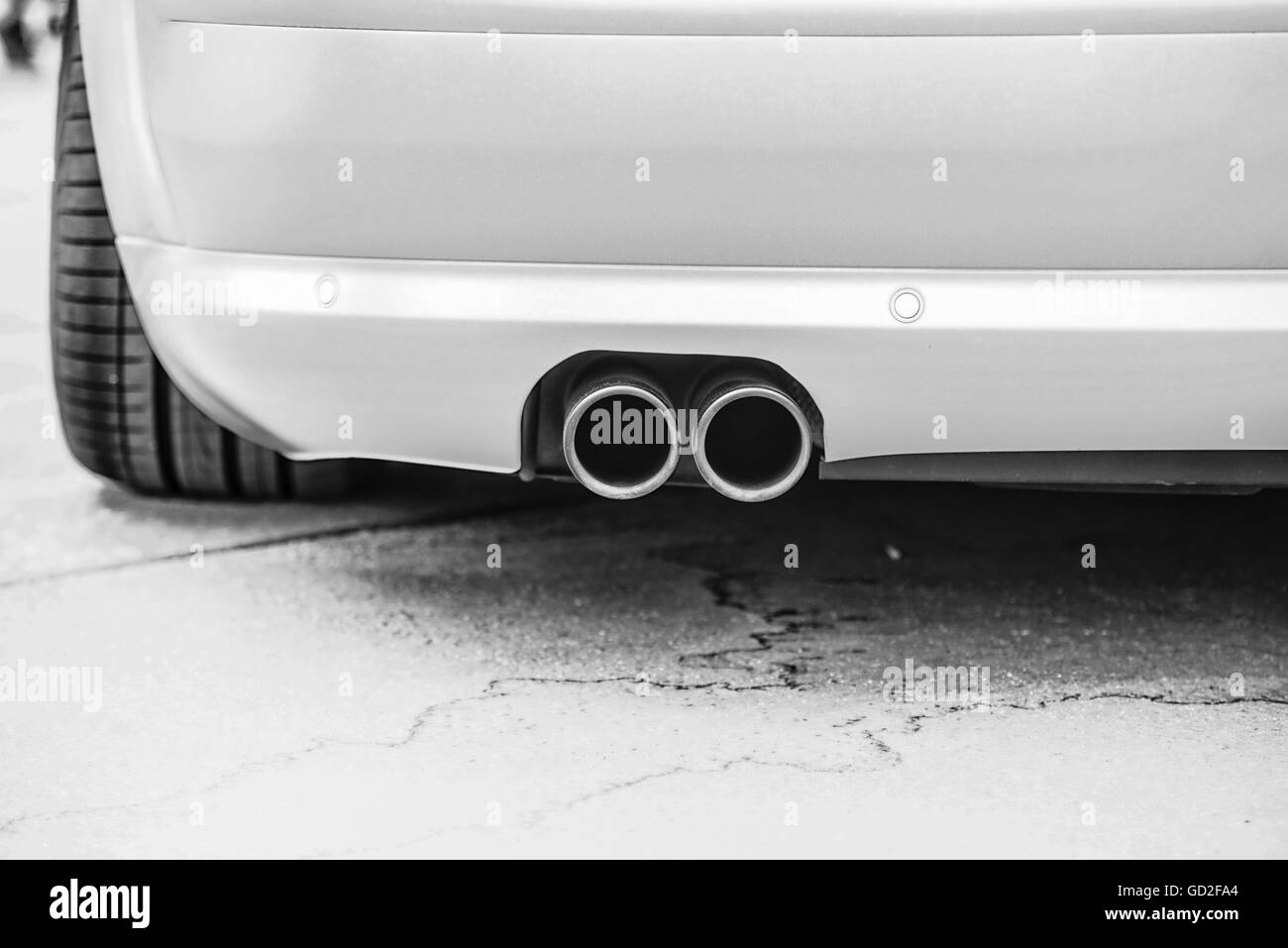 Double exhaust pipes of a modern sports car, black and white Stock ...