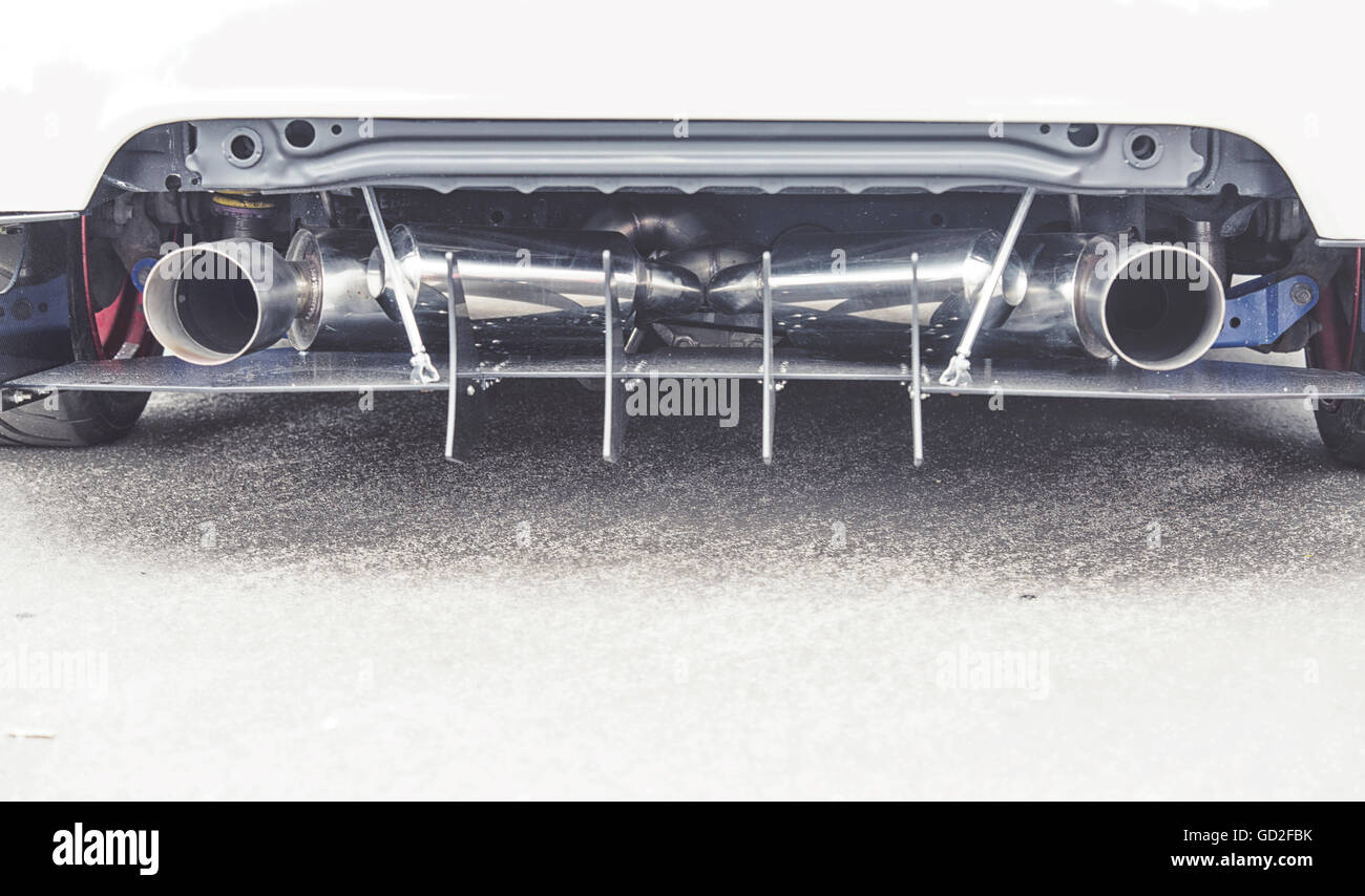 Double exhaust pipes of a modern sports car, black and white Stock ...