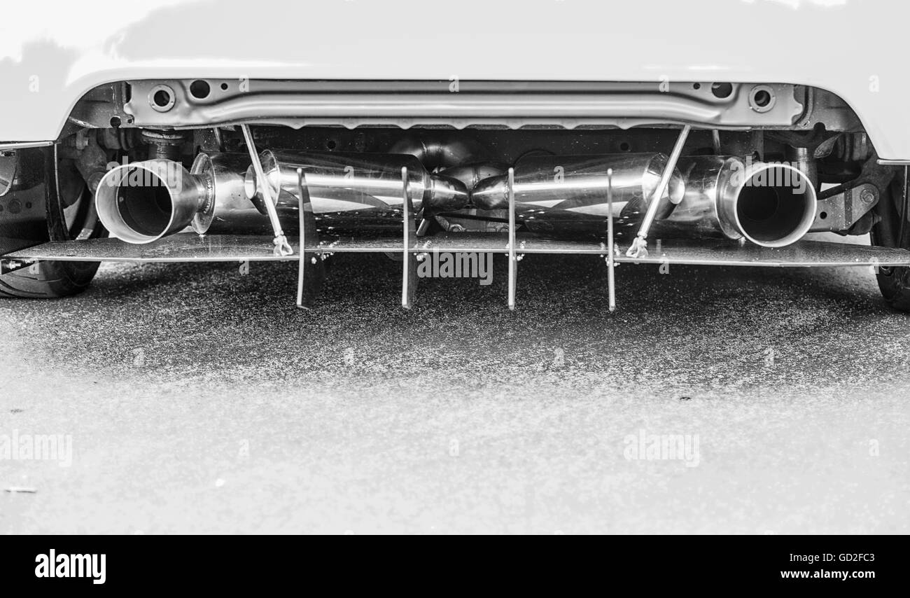 Double exhaust pipes of a modern sports car, black and white Stock ...