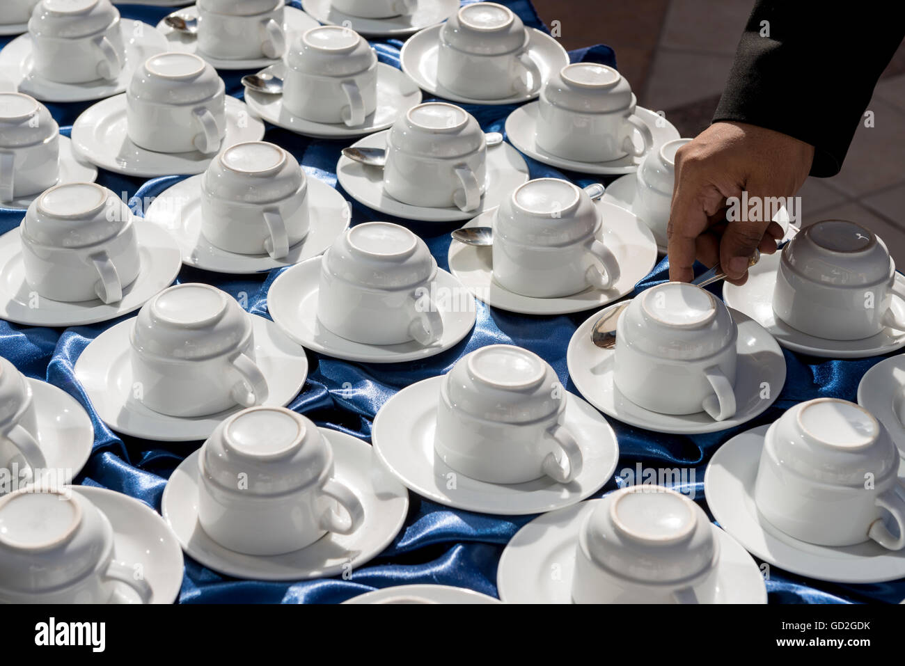 A Prepared Coffee Break Table with Mugs and Spoons Stock Photo - Alamy