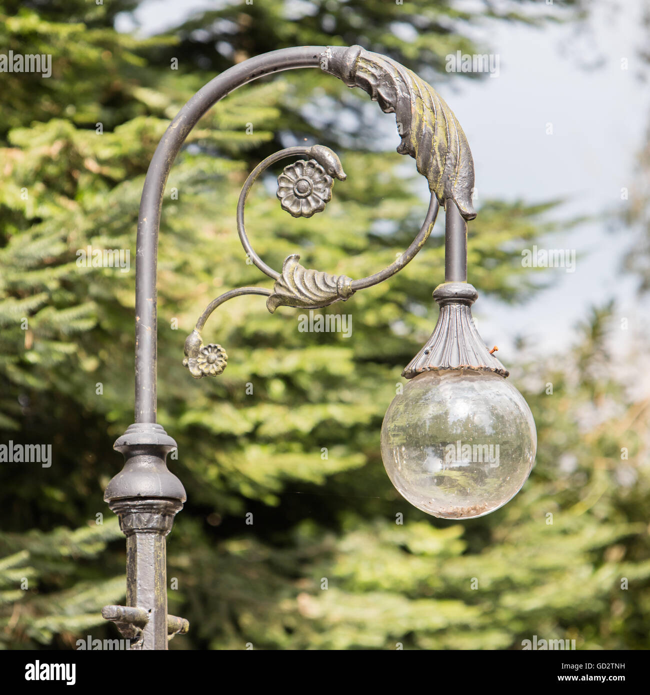 Decorative street lamp-post, trees in the background Stock Photo - Alamy
