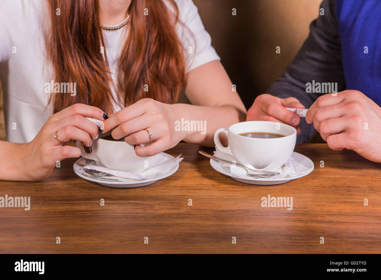 Hands of a woman and a man putting sugar in a cup Stock Photo - Alamy