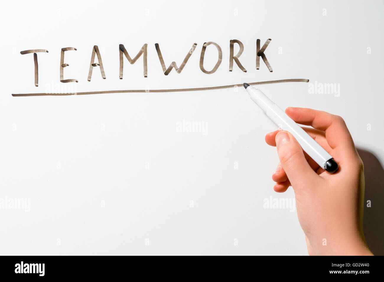 woman writing with a black marker on a board teamwork Stock Photo - Alamy
