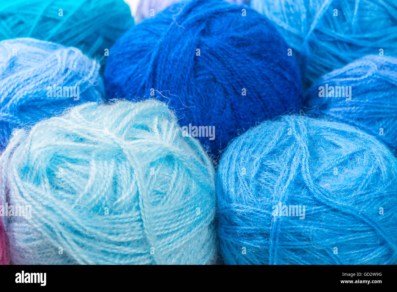 blue and turquoise wool skeins of thread closeup Stock Photo - Alamy