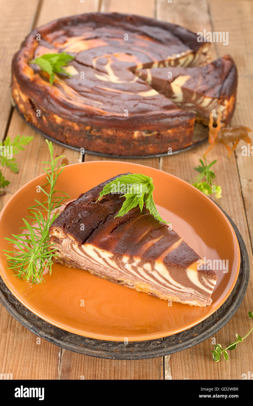 Homemade round chocolate zebra cheesecake Stock Photo - Alamy