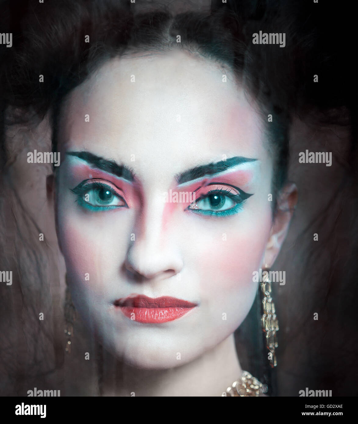 Close up stylized portrait of a Japanese geisha with bright make up ...