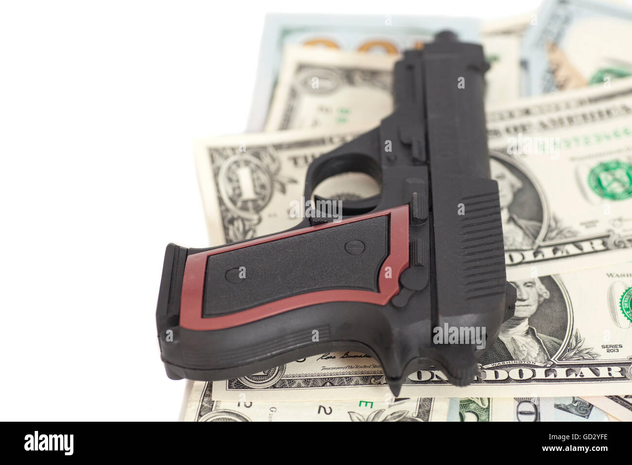 Gun on US dollar banknotes isolated on white Stock Photo - Alamy