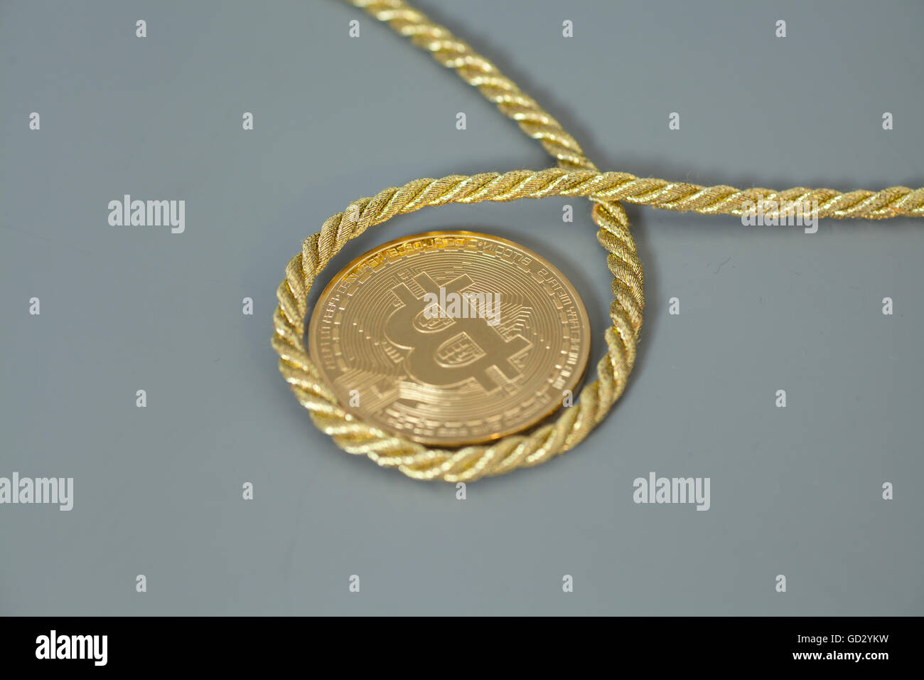 Golden Bitcoin coin with golden rope isolated on gray background Stock ...