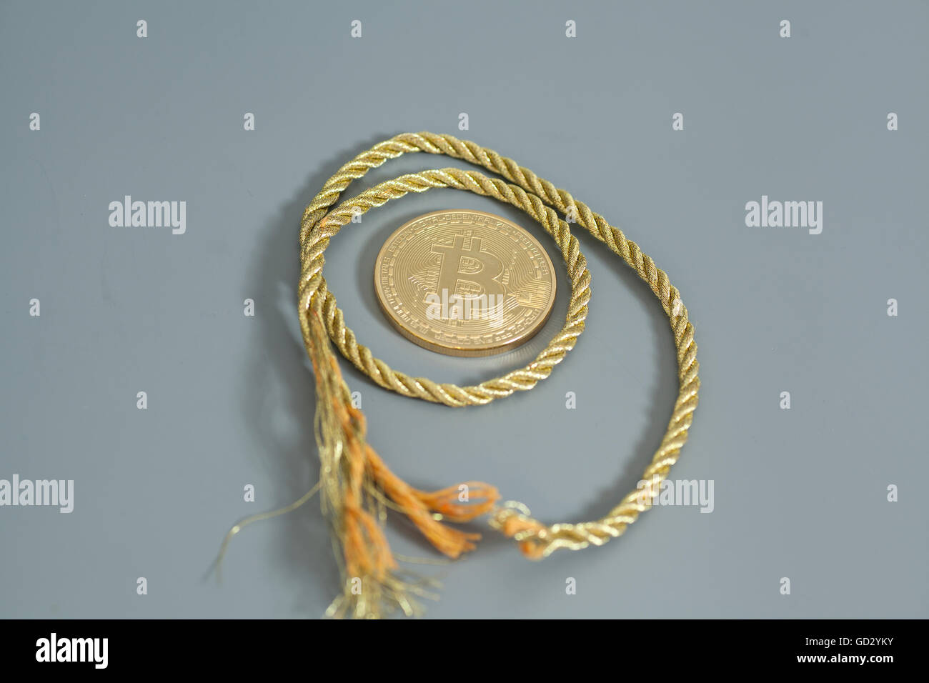 Golden Bitcoin coin with golden rope isolated on gray background Stock ...
