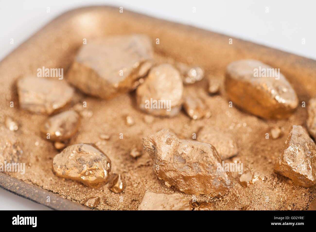 Golden nuggets on grungy wash pan with sand on white background Stock ...