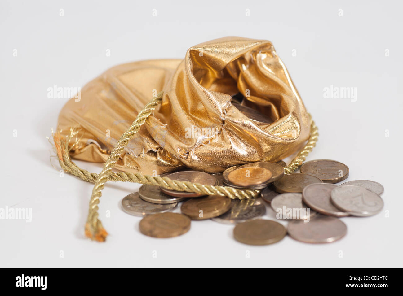 Bag with golden rope of coins on a white background Stock Photo - Alamy