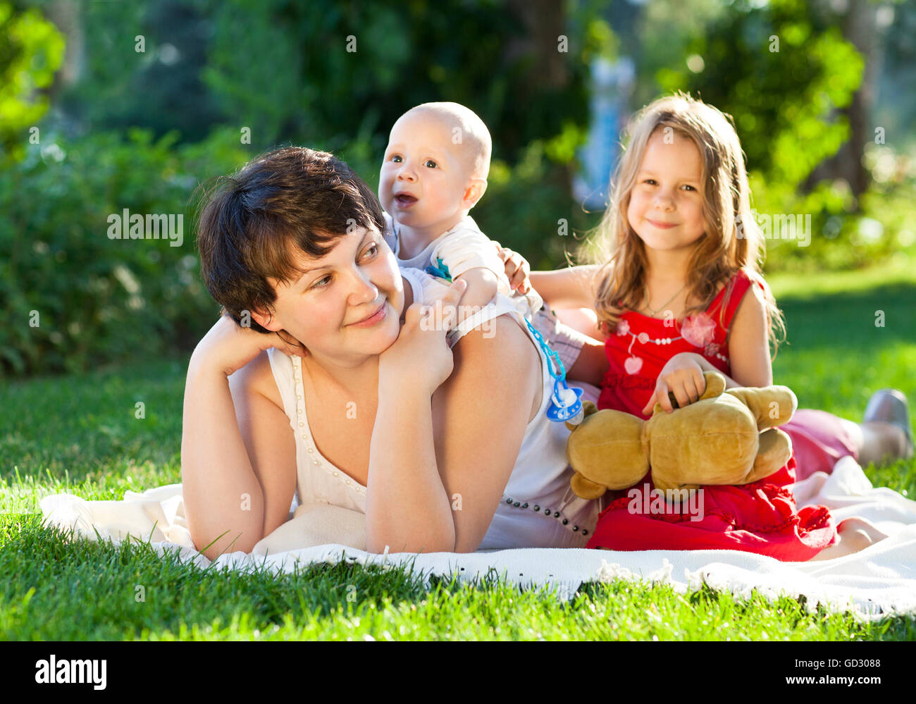 Mother And her kids outdoors. Happy mum and her children playing in ...