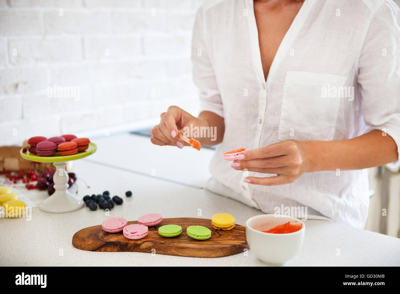 Woman cooking homemade macarons at the kitchen Stock Photo - Alamy