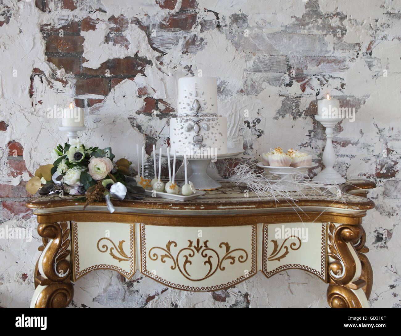 Sweet bar with white wedding cake with silver decoration and wedding ...