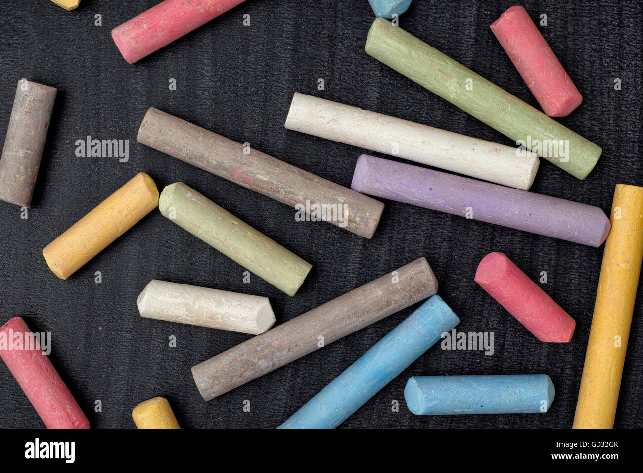 Colorful chalks on blackboard. Close up Stock Photo - Alamy