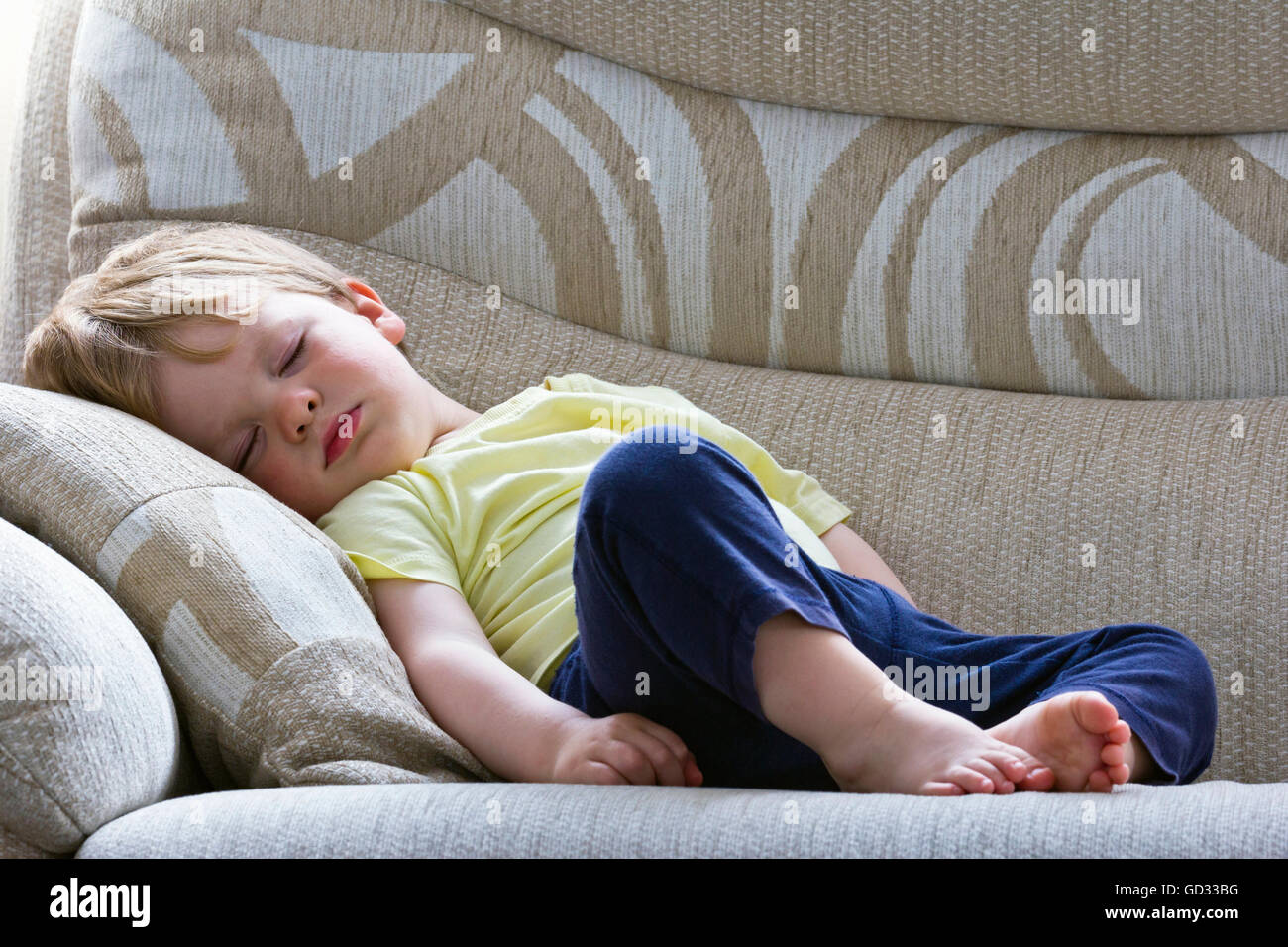 Young boy asleep on the sofa Stock Photo - Alamy