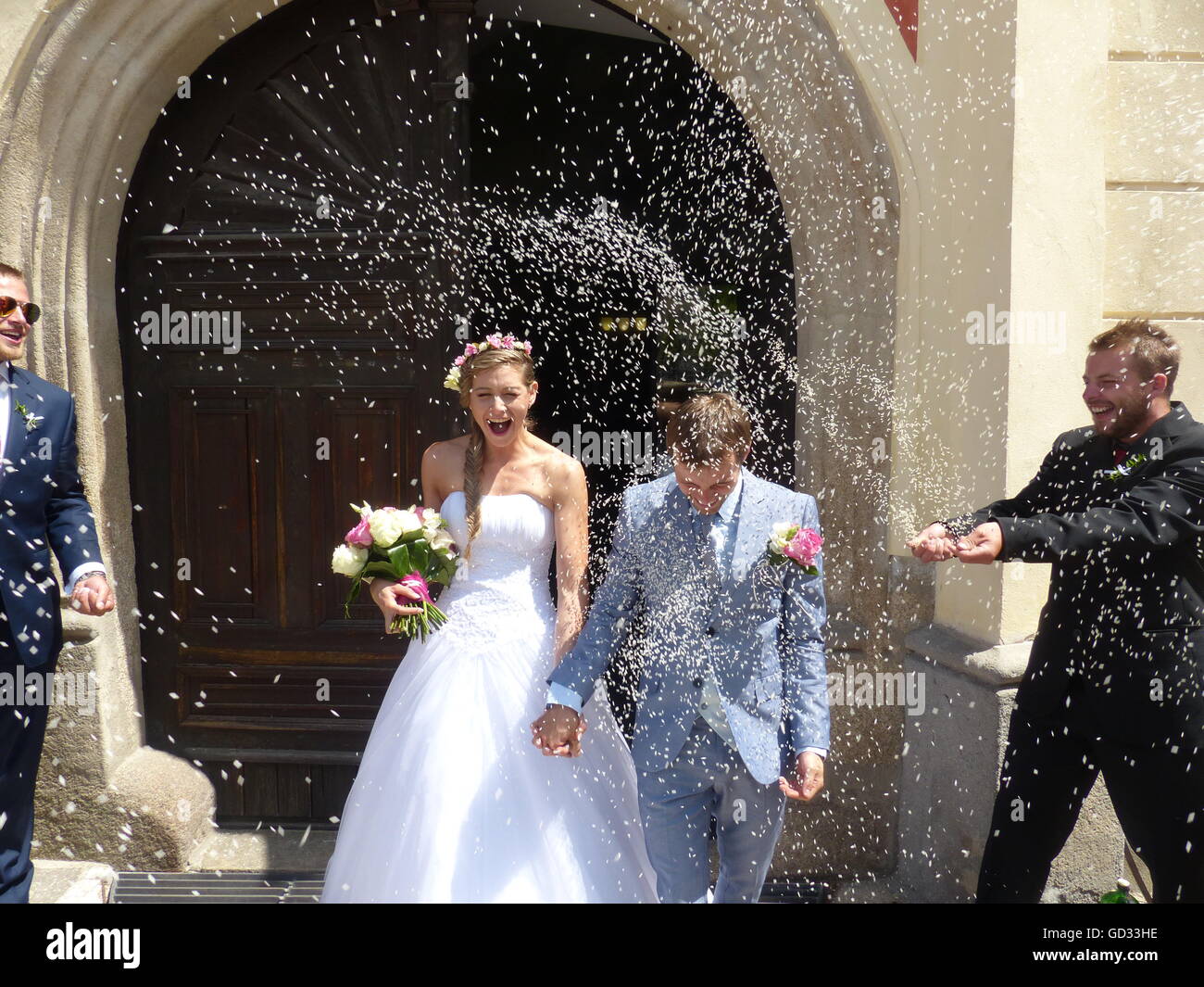 Traditional rice throwing at newlyweds takes place after married couple ...