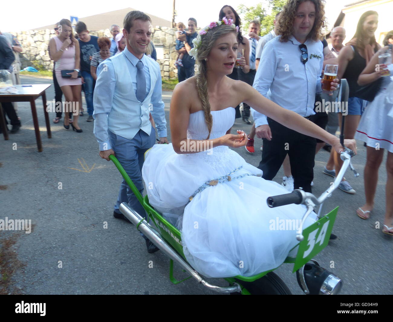 Traditional wheelbarrow run when bride is locked by chain during ...