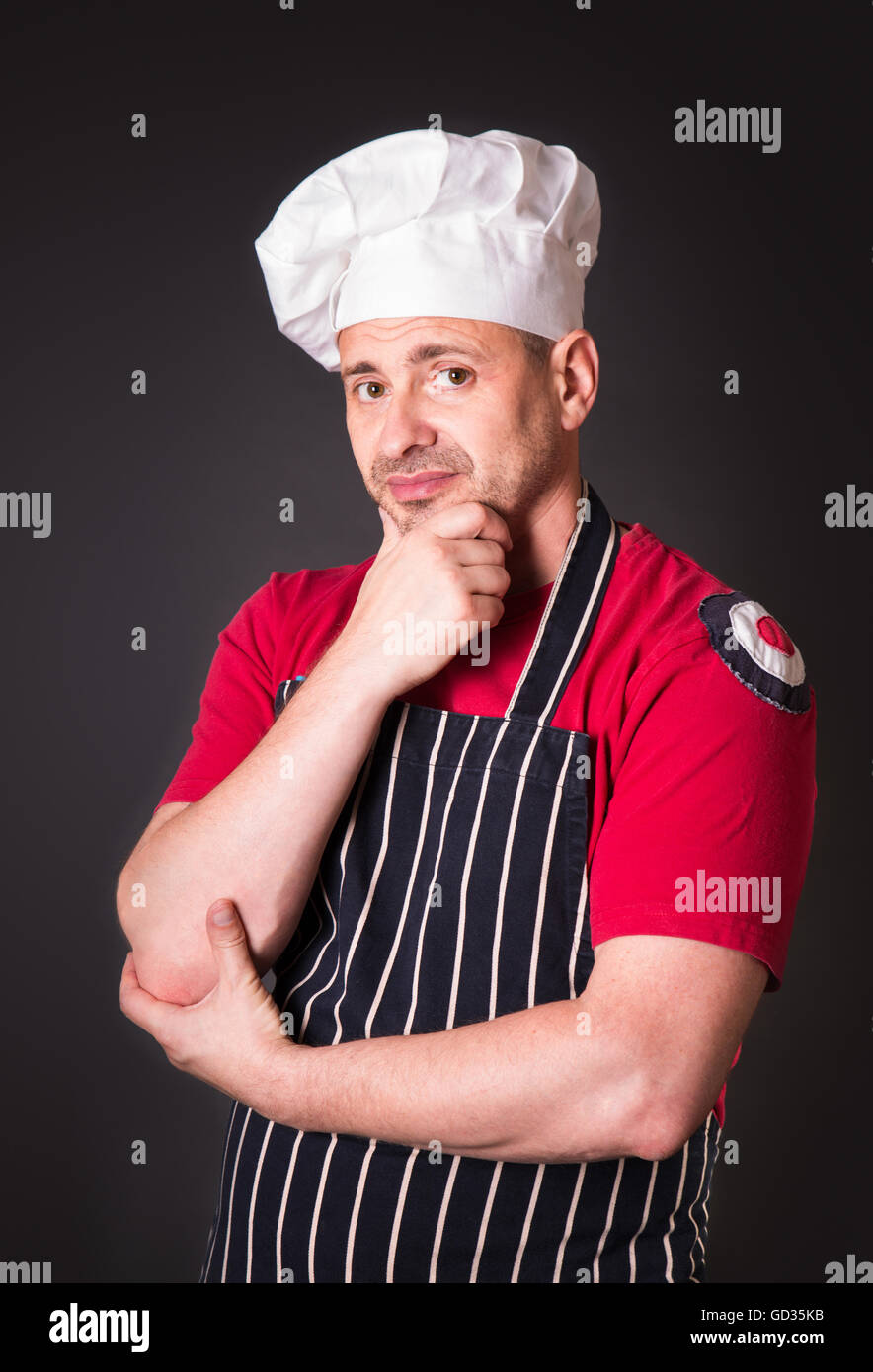 Portrait of a chef with a sad expression on his face in the studio on a ...