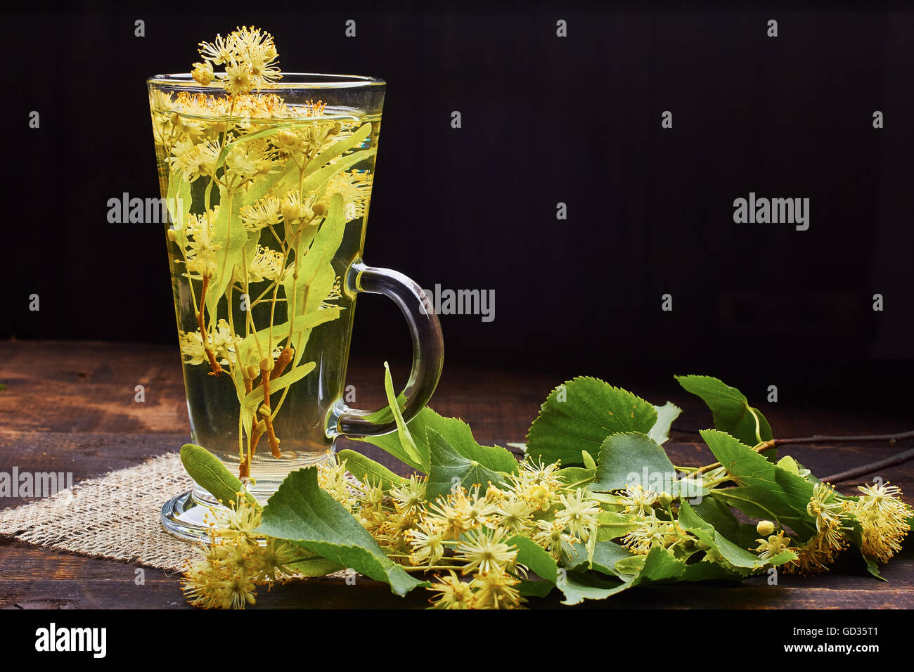 Glass cup of linden tea with fresh flowers Stock Photo - Alamy