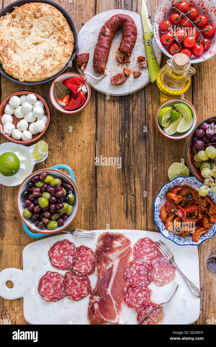 tapas background, overhead on wooden table Stock Photo - Alamy