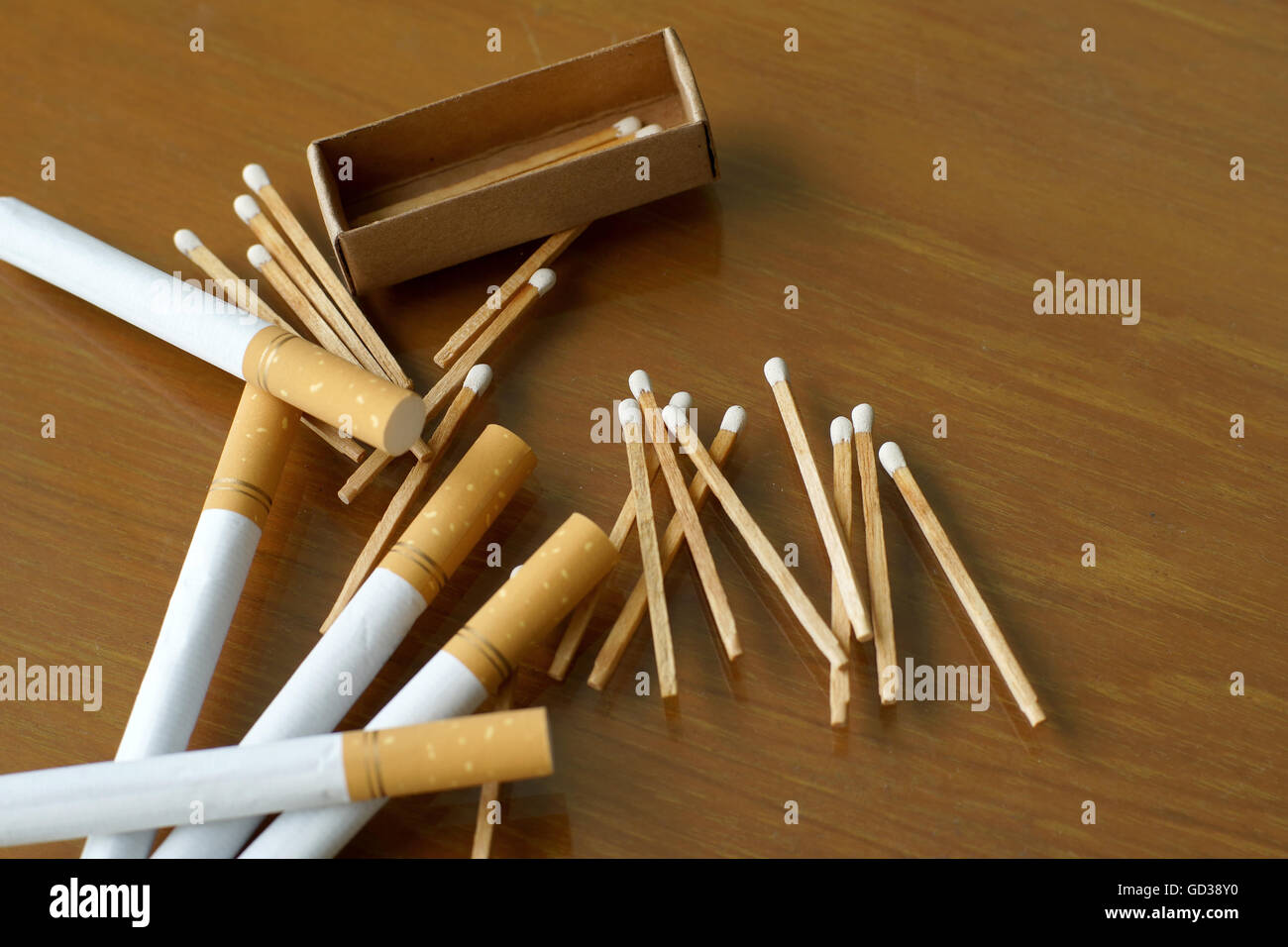 matchstick matchbox and cigarette on wooden table Stock Photo - Alamy
