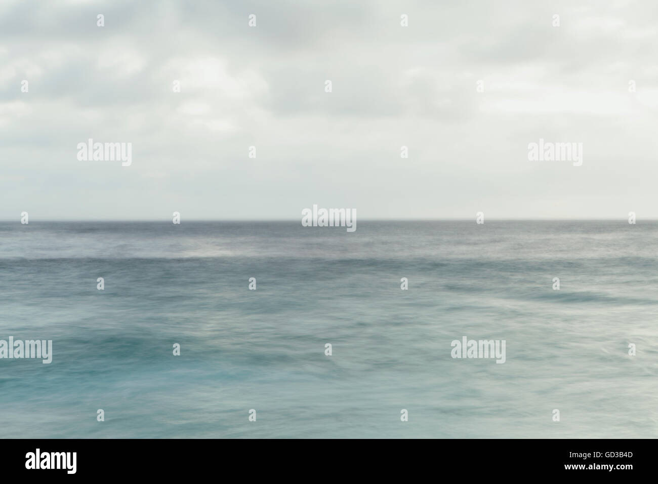 Calm ocean water and overcast sky Stock Photo - Alamy