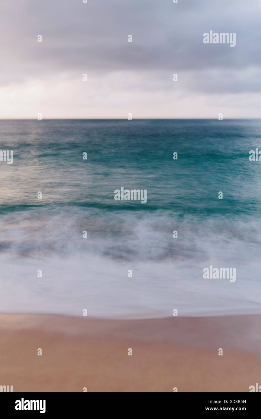 The ocean viewed from the beach, waves breaking on the beach and ...