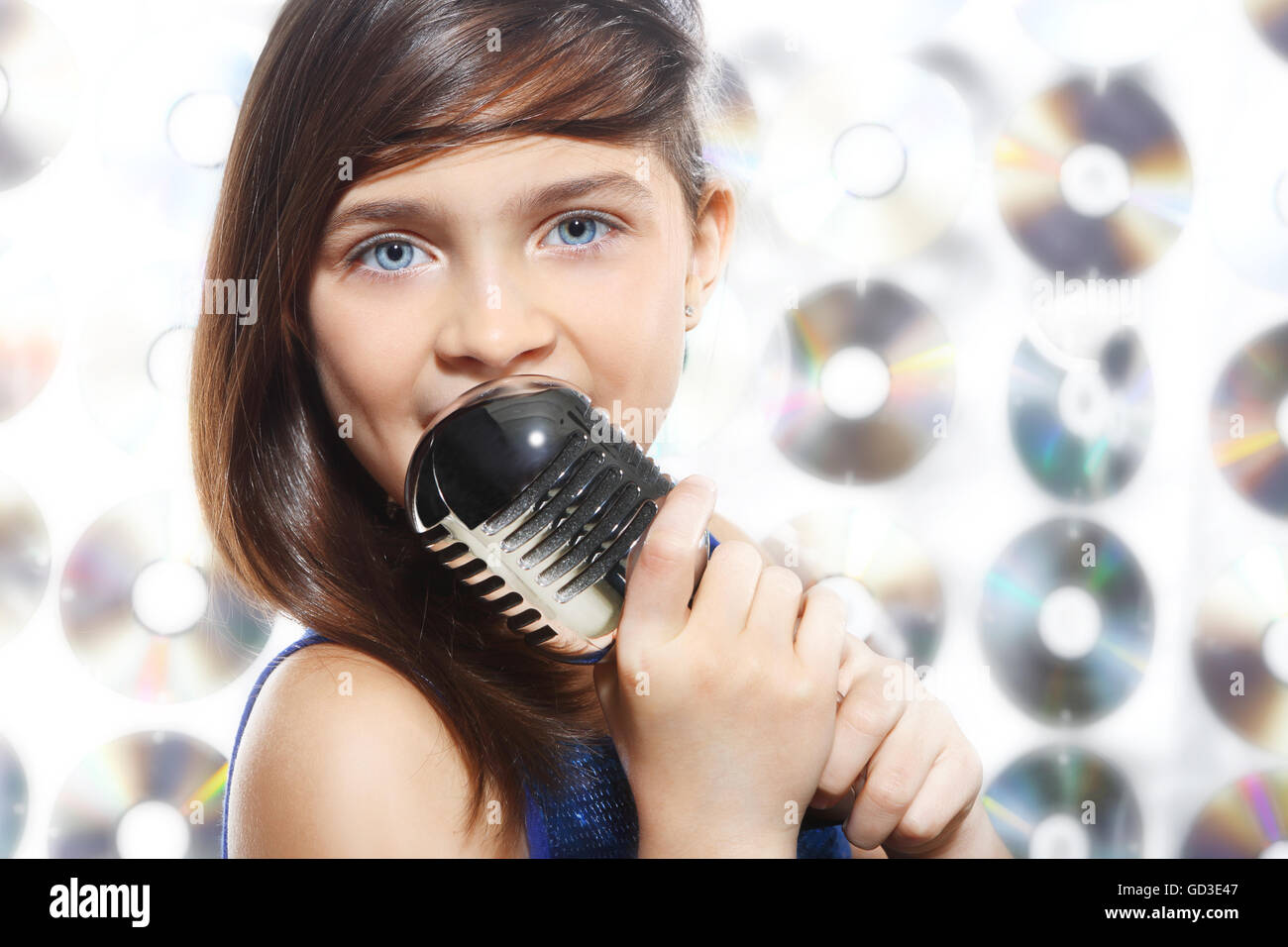 Child, teen, girl, singing into a microphone, a small singer Stock Photo - Alamy